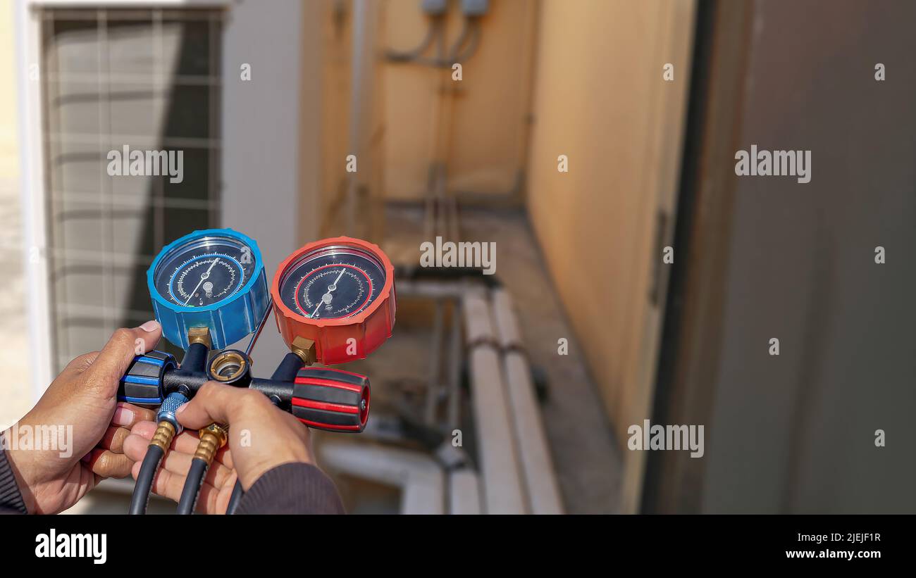 Air conditioner technician checking air conditioner operation Stock ...