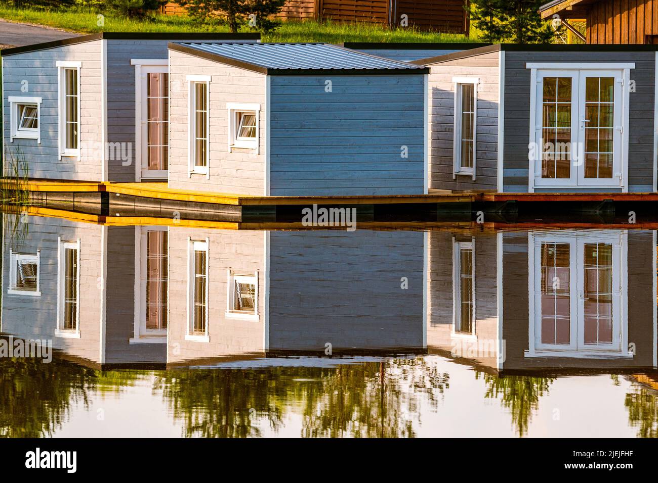 Floating cabins with nice reflection on the lake water in a sunny day ...