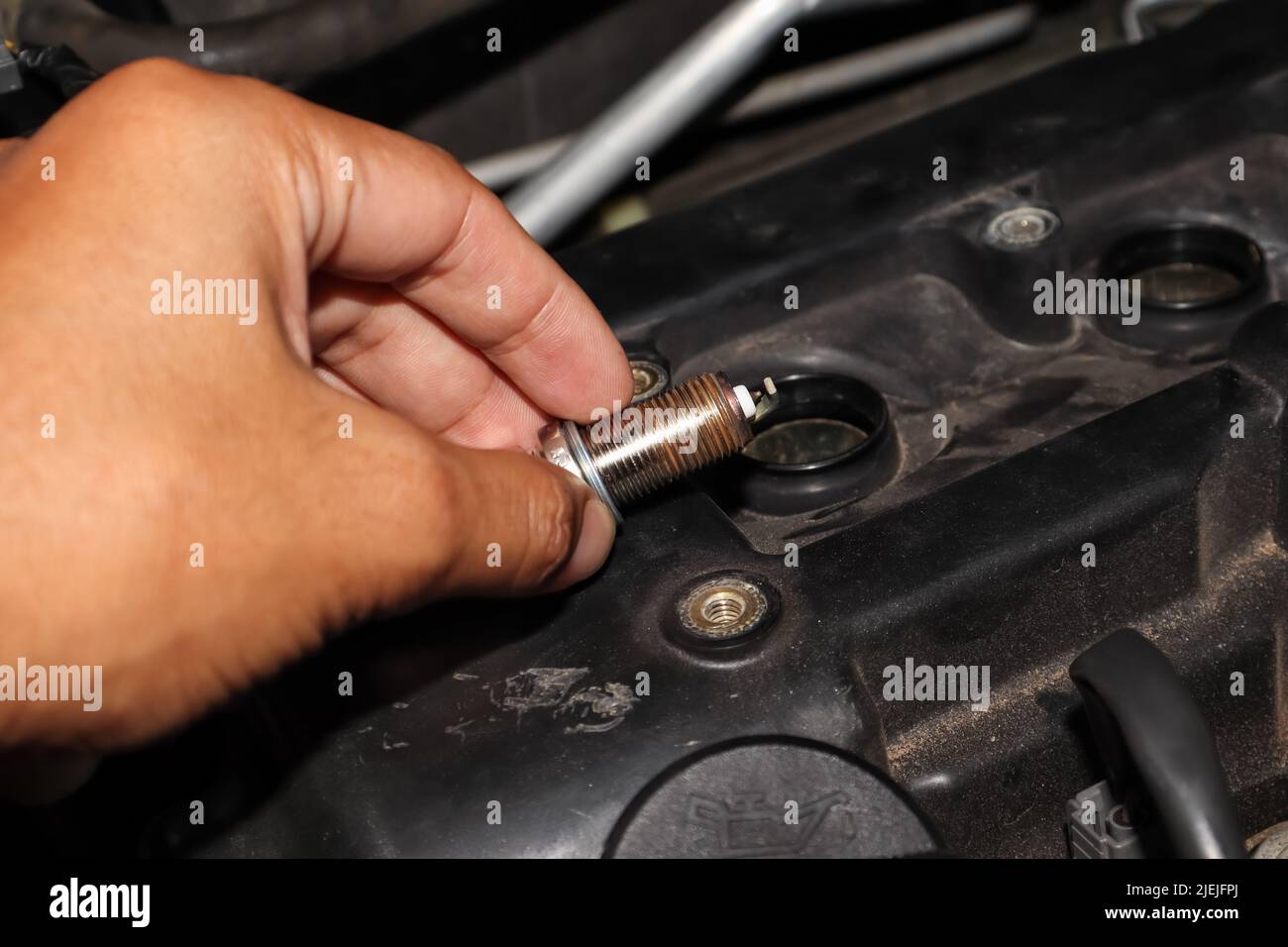 Maintenance spark plug of car Stock Photo - Alamy