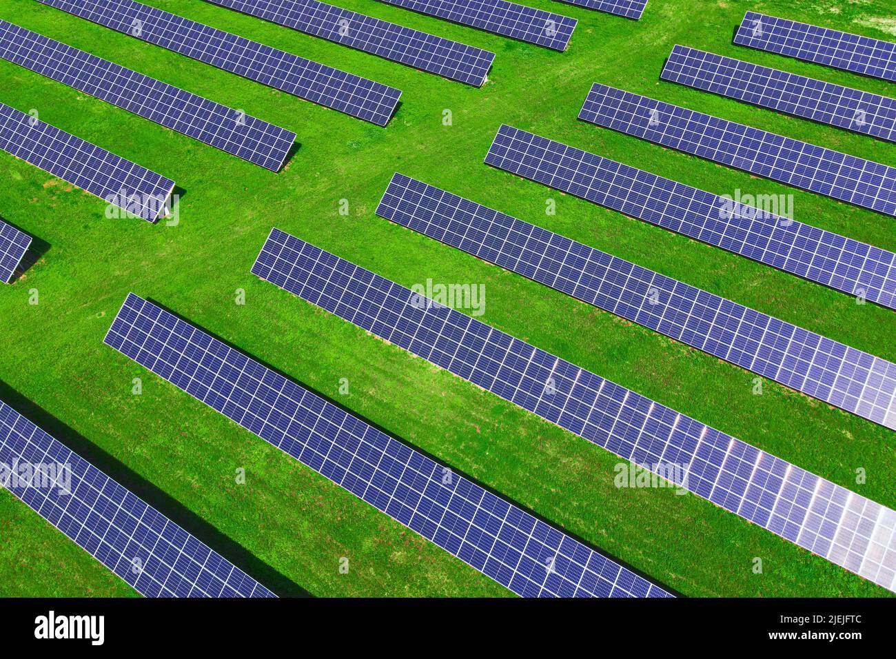 Solar panels battery in green field, aerial view. Photovoltaic modules ...