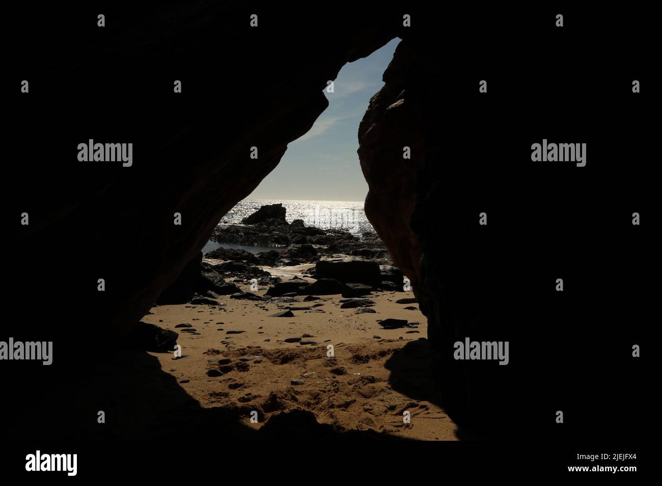Inside cave on the beach with view on the sea Stock Photo - Alamy