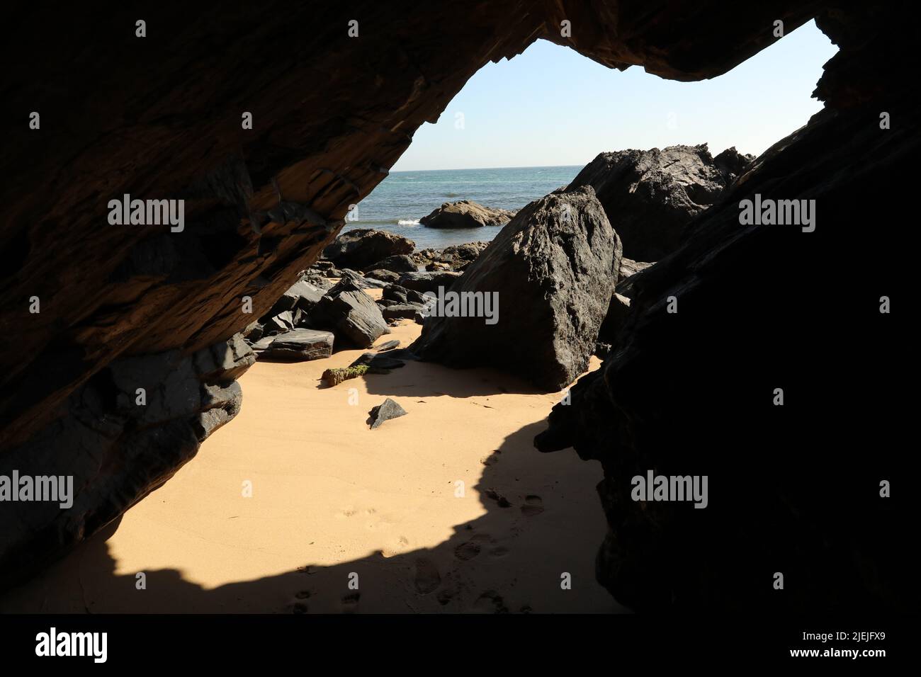 Inside cave on the beach with view on the sea Stock Photo - Alamy