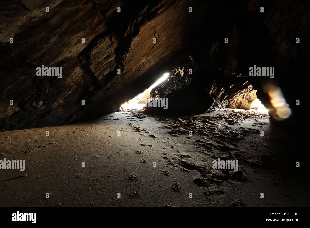 Inside cave on the beach with view on the sea Stock Photo - Alamy