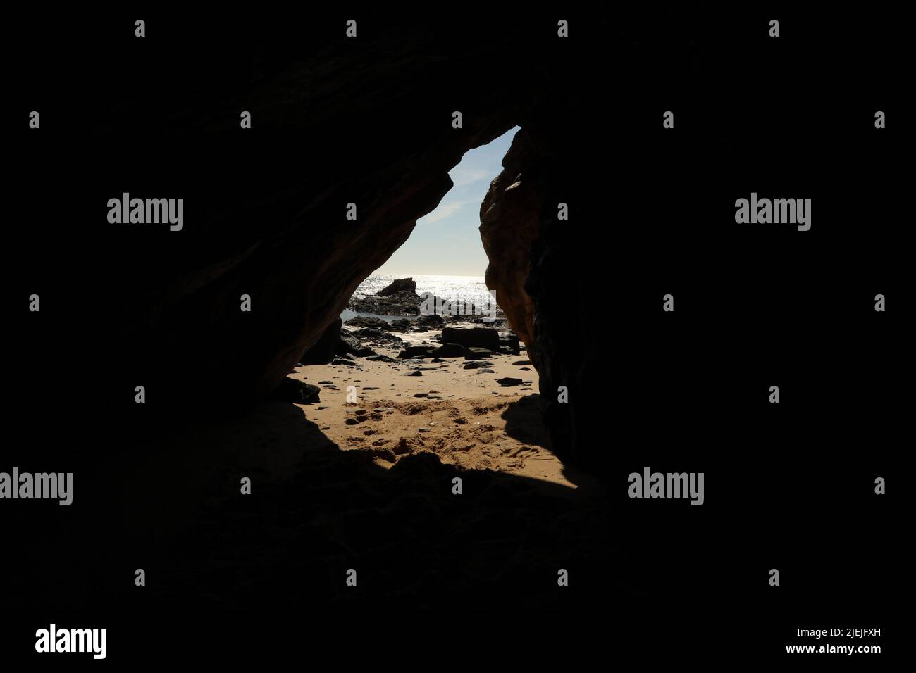 Inside cave on the beach with view on the sea Stock Photo - Alamy