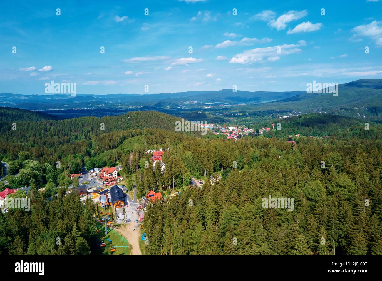 Aerial view of beautiful mountains, covered with forest and village ...