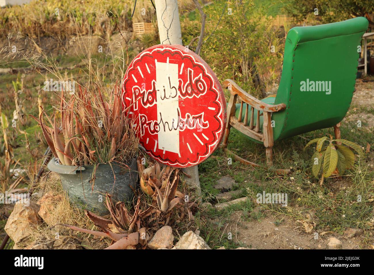 Prohibido sign with written on it next a sofa in a garden Stock Photo ...
