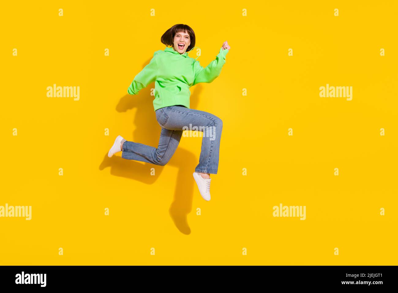 Full length body size view of attractive amazed cheerful girl jumping ...