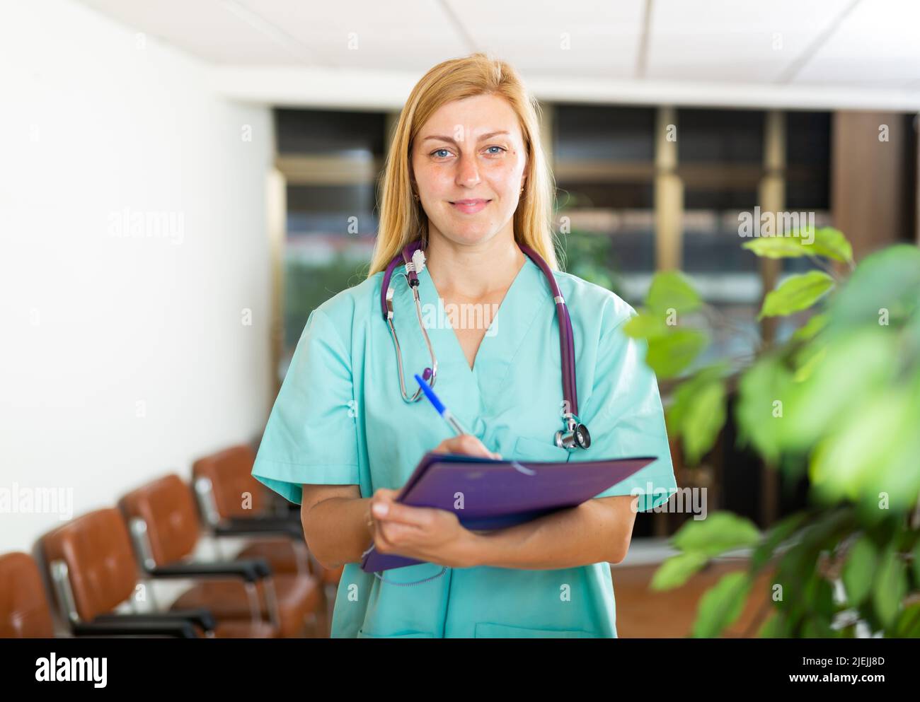Female doctor assistant standing in medical office Stock Photo - Alamy