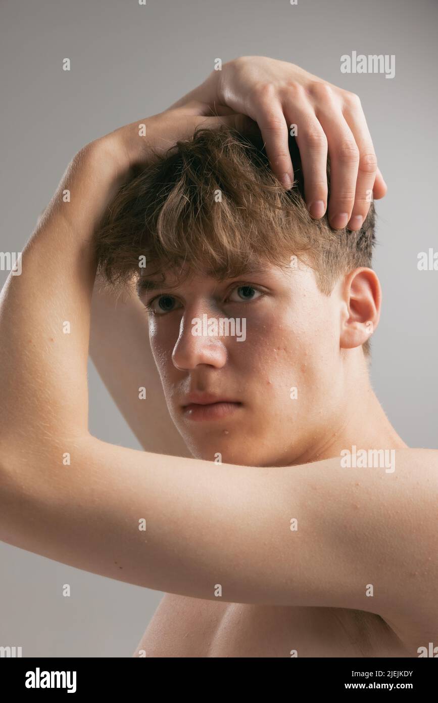 Beauty portrait of young man, teen isolated on grey studio background ...