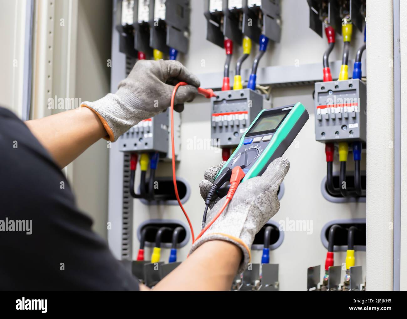Engineering inspecting the operation of electrical control equipment ...