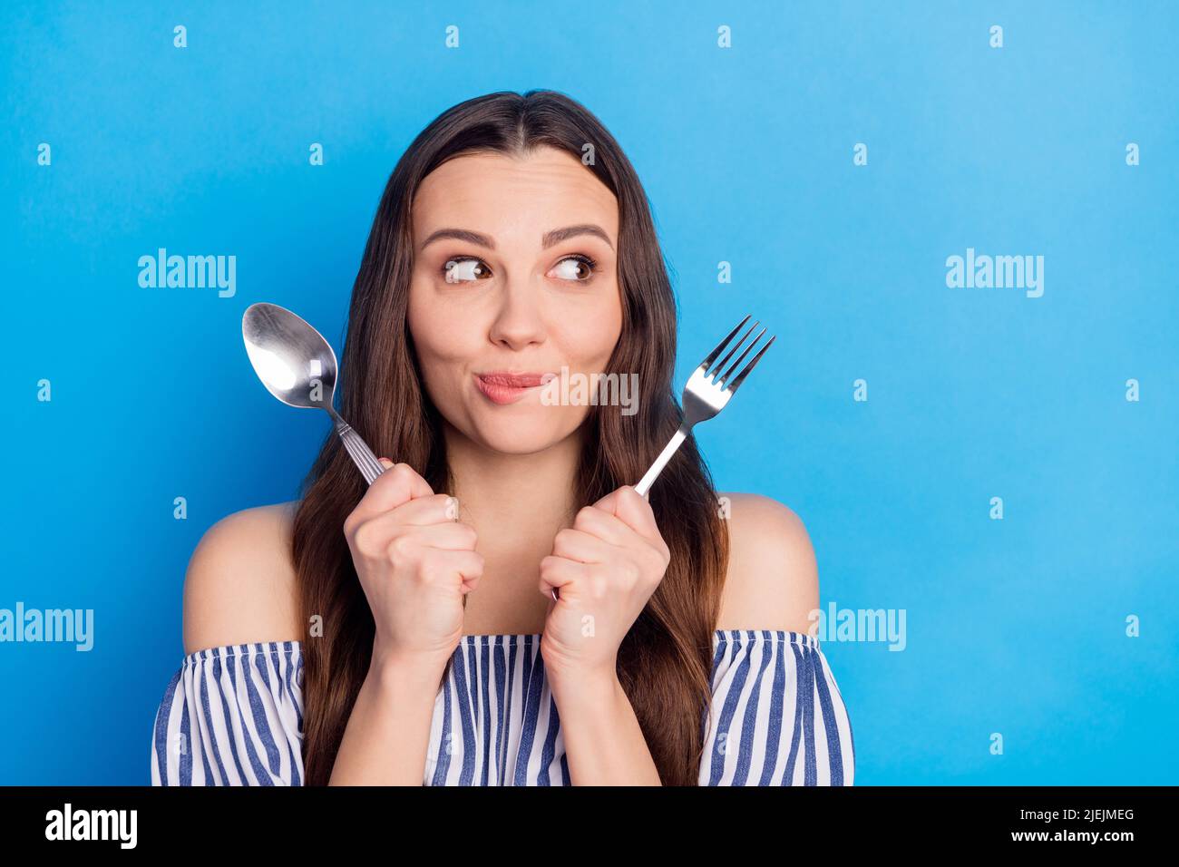 Photo portrait woman hungry wait for dinner with fork knife biting lip ...