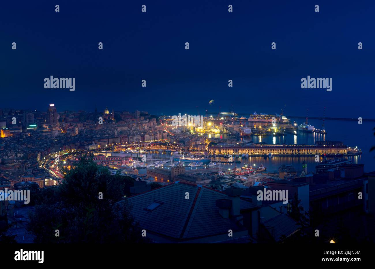 Night cityscape of Genova with the old port, cruise ships, sea and port ...