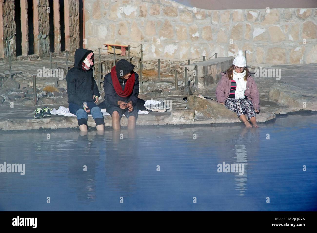 Tourists are taking a bath in a natural swimming pool at the El Tatio ...