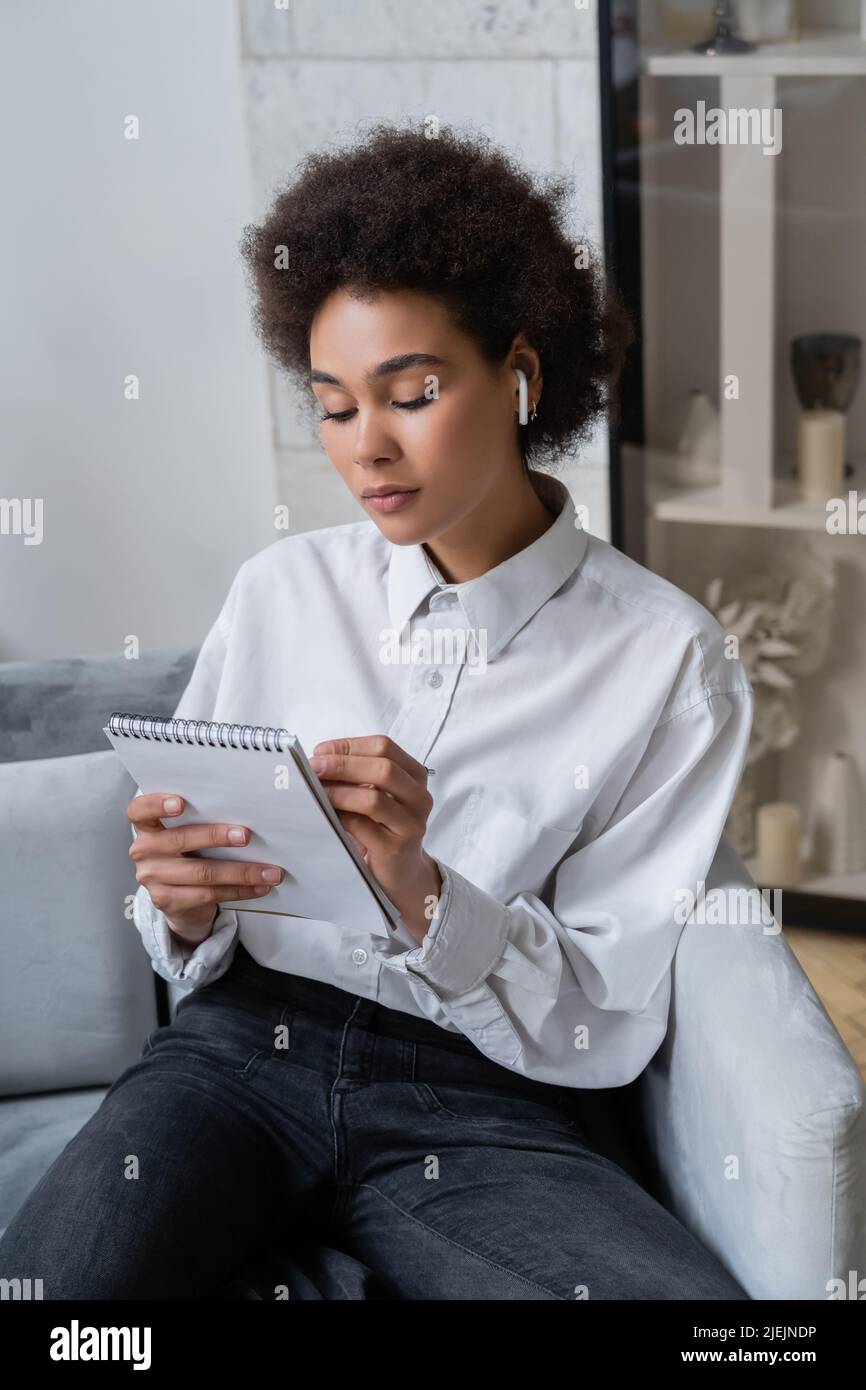 Curly brunette woman making notes hi-res stock photography and images ...
