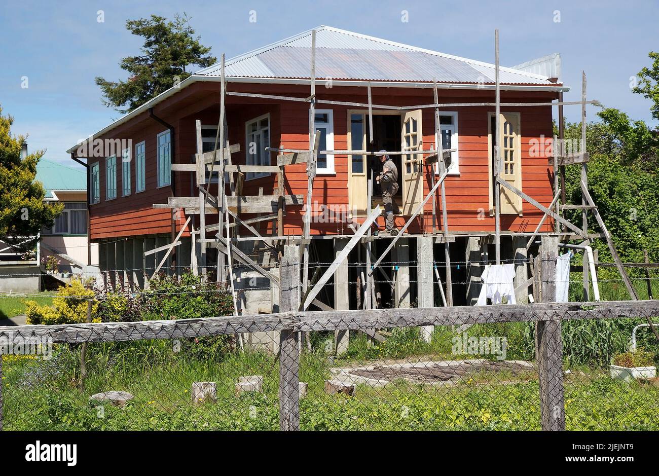 A man is building a traditional wodden house in Chiloe island, Chile ...