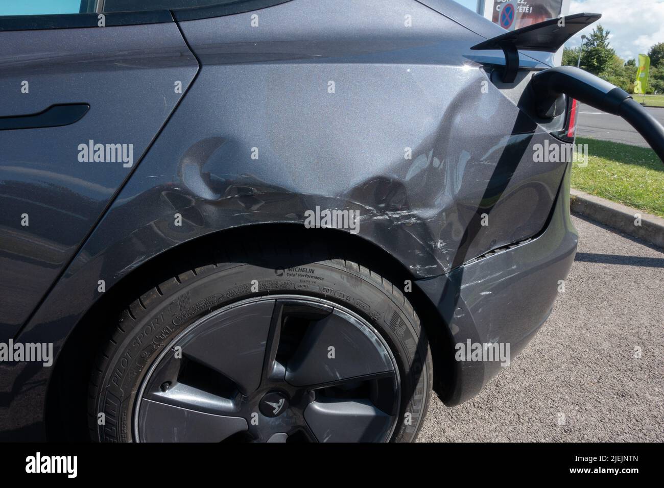 Tesla Model 3 charging with damaged quarter panel Stock Photo - Alamy