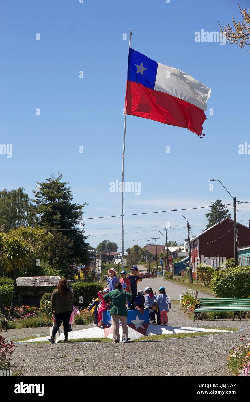 Young students around the flags of Chile at the Chacao village in the ...