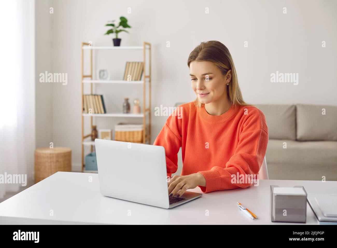 Ambitious young woman working remotely or distance learning at home ...