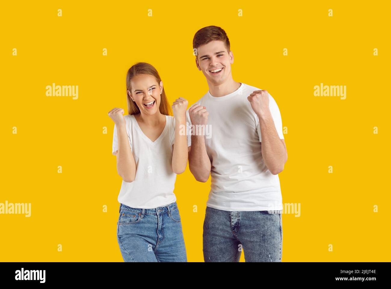 Excited couple make yes hand gesture celebrate win Stock Photo - Alamy