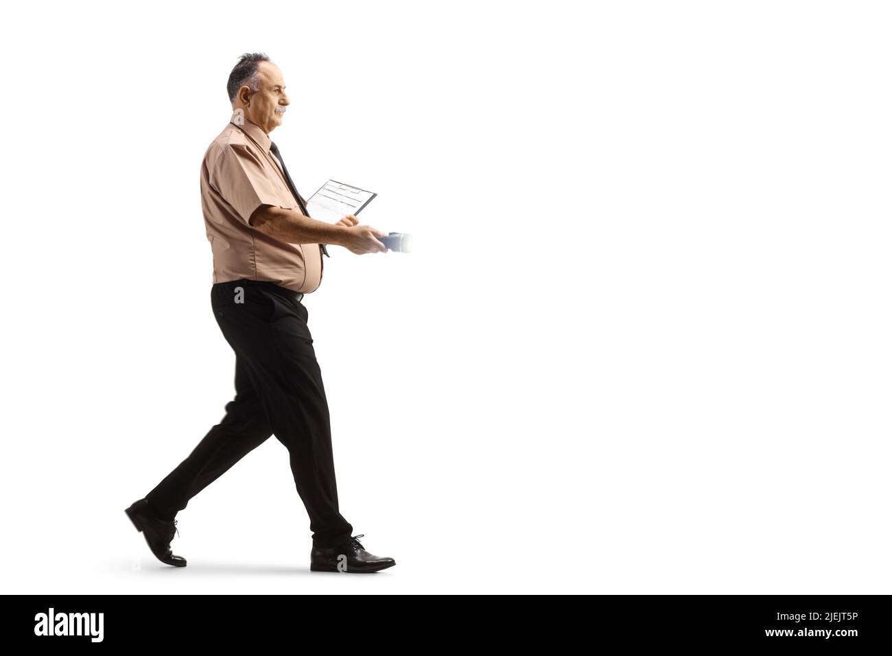 Full length profile shot of a mature security officer walking and ...