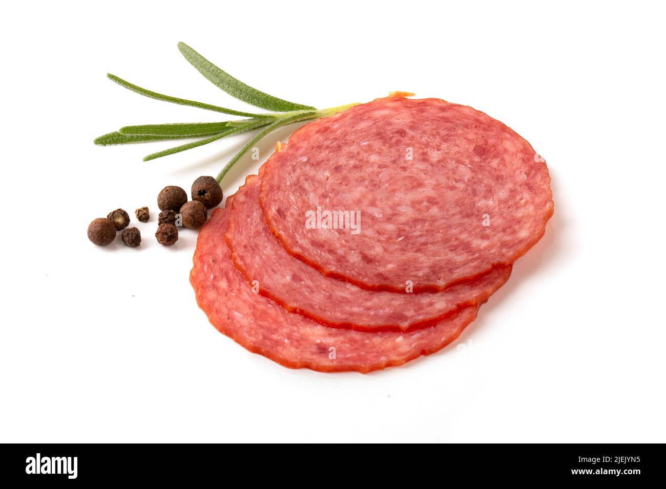 Sliced round pieces of salami sausage with rosemary leaf on a white background Stock Photo - Alamy