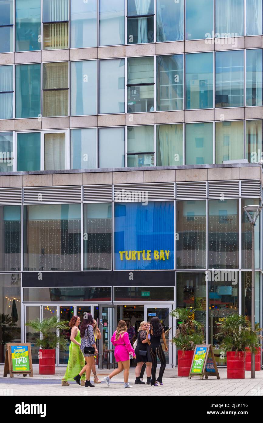 Young women walking past Turtle Bay Caribbean Eating & Drinking ...