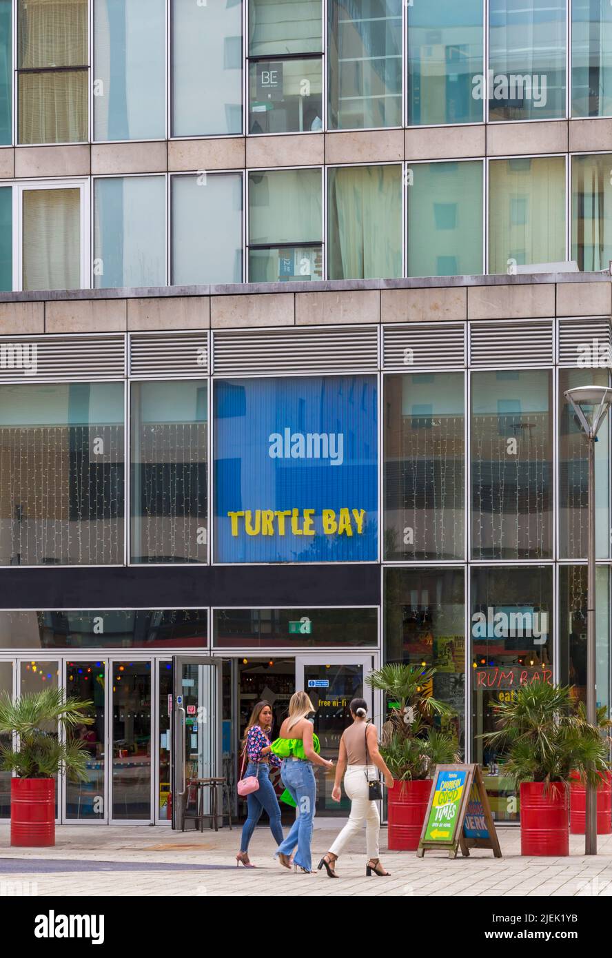 Young women walking past Turtle Bay Caribbean Eating & Drinking ...