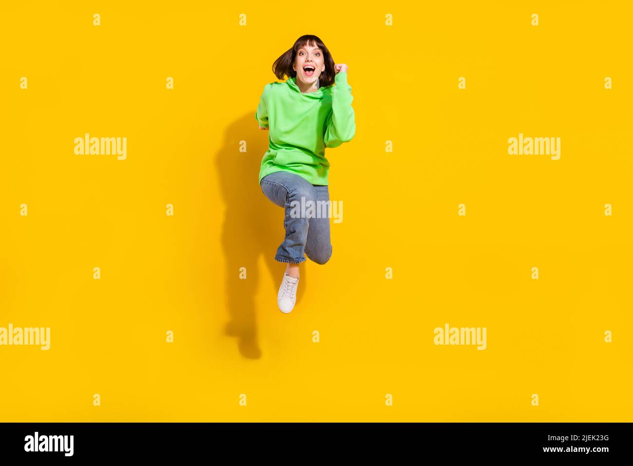 Full length body size view of attractive cheerful girl jumping running ...