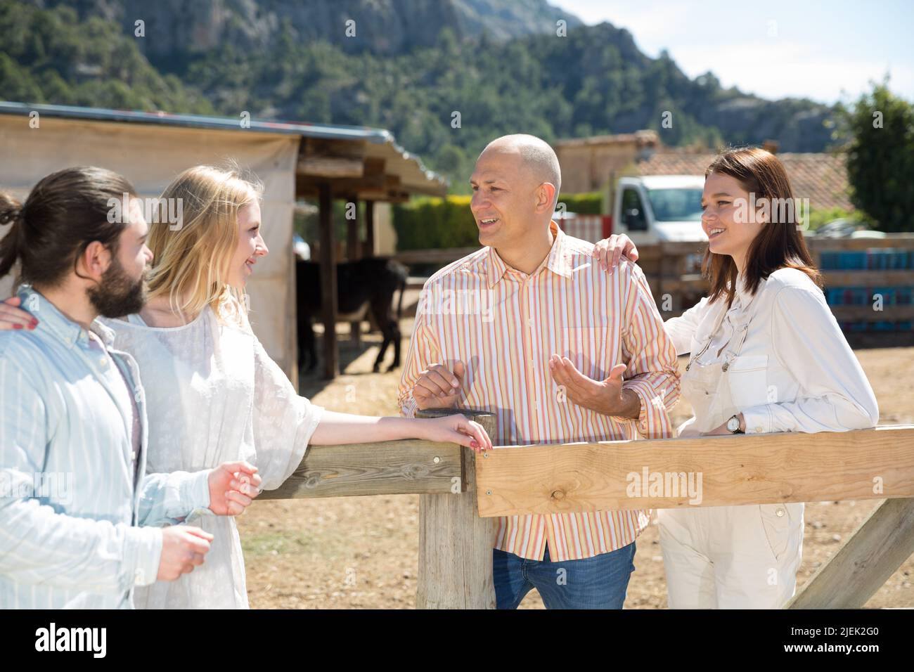 Two couples having cheerful talk outdoors Stock Photo - Alamy