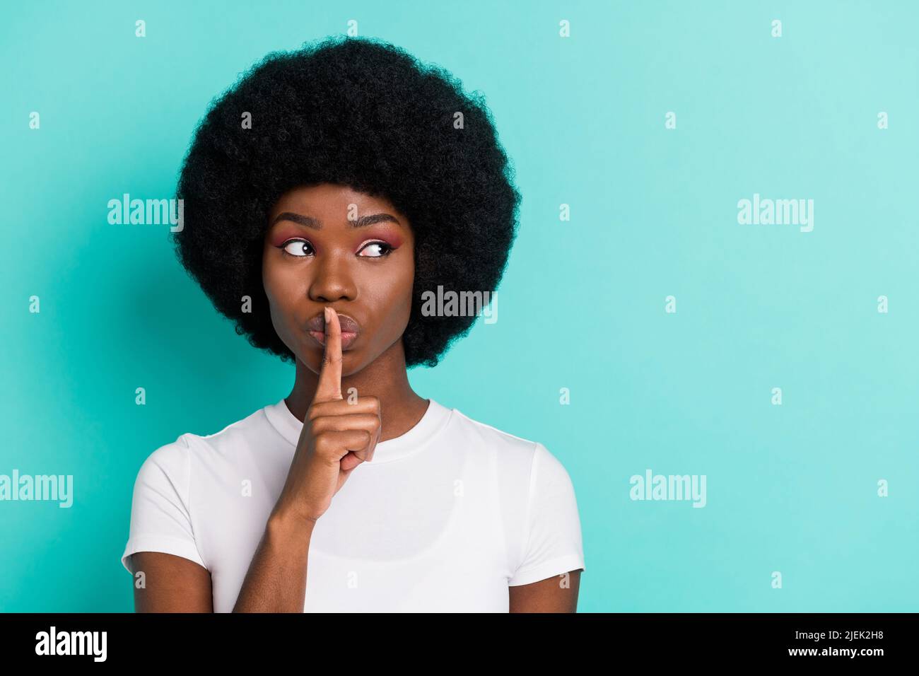 Photo of young serious dark skin woman look empty space hold finger ...