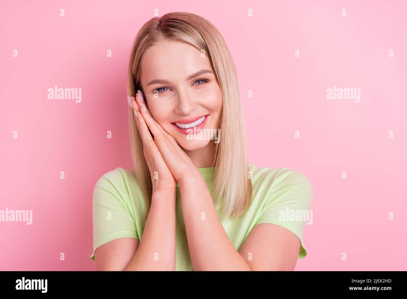 Photo Of Peaceful Adorable Lady Hands Cheek Toothy Smile Wear Green T