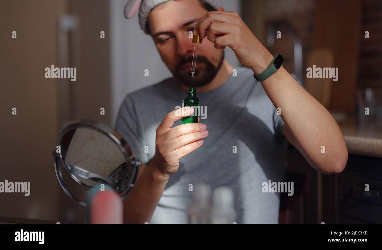 Men's beauty concept. caucAsian guy checking his skin. Skin nutrition ...