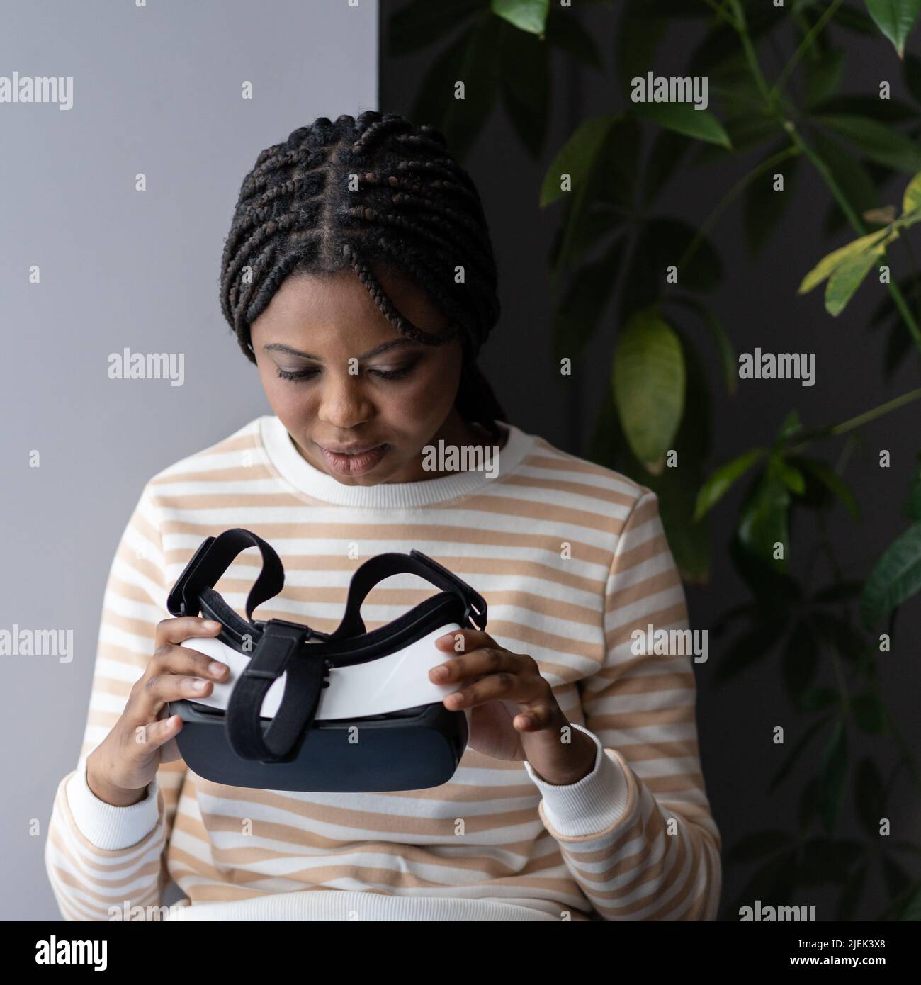 Interested african woman hold goggles for virtual reality simulation ...