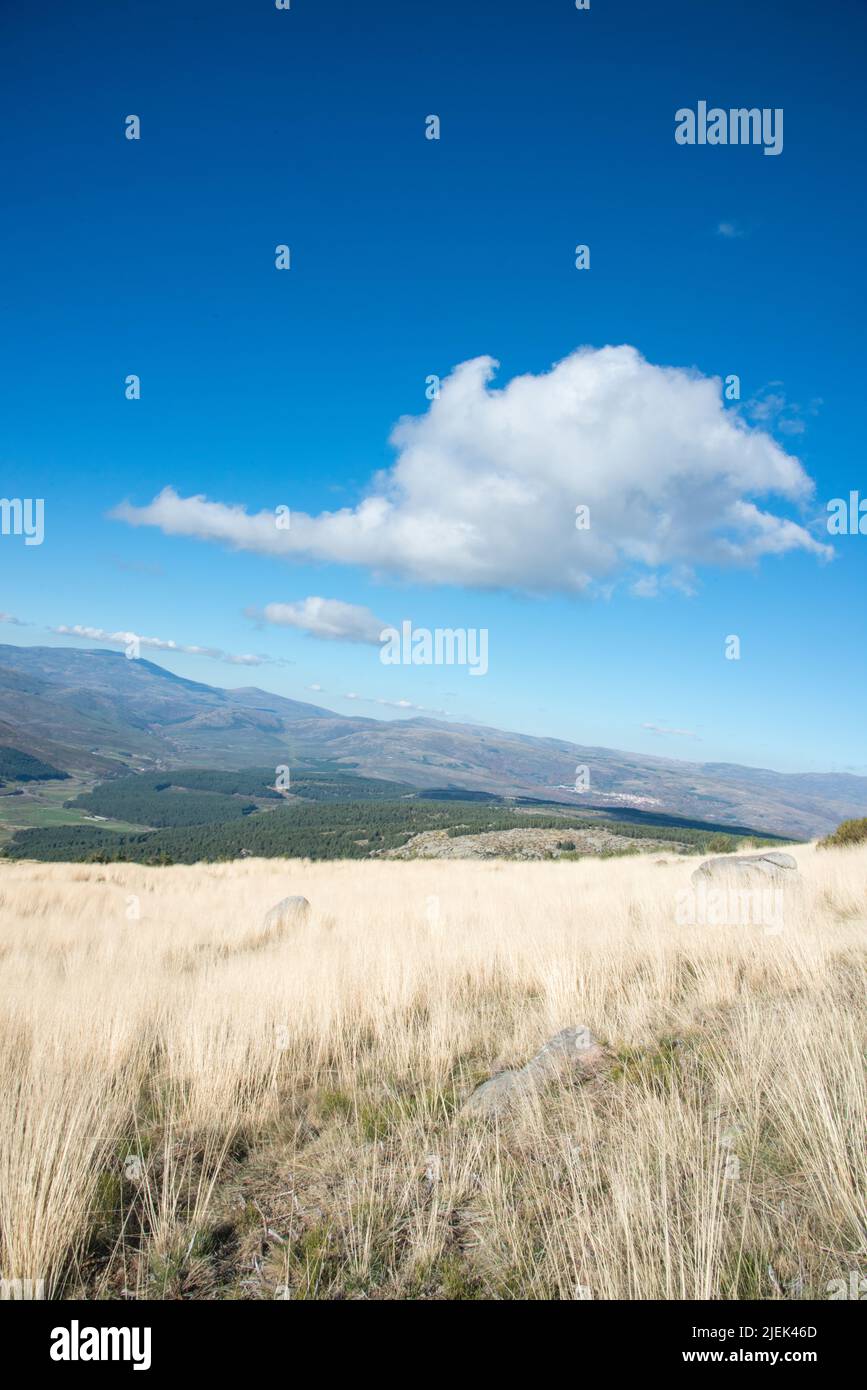 Cute clouds over the countryside in Avila. Blue sky and hills in the ...