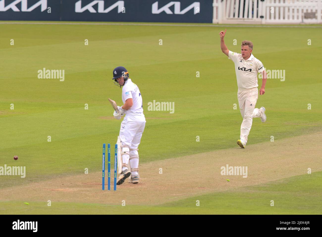 27 June, 2022. London, UK. Surrey’s Sam Curran bowls Kent’s Ben Compton ...
