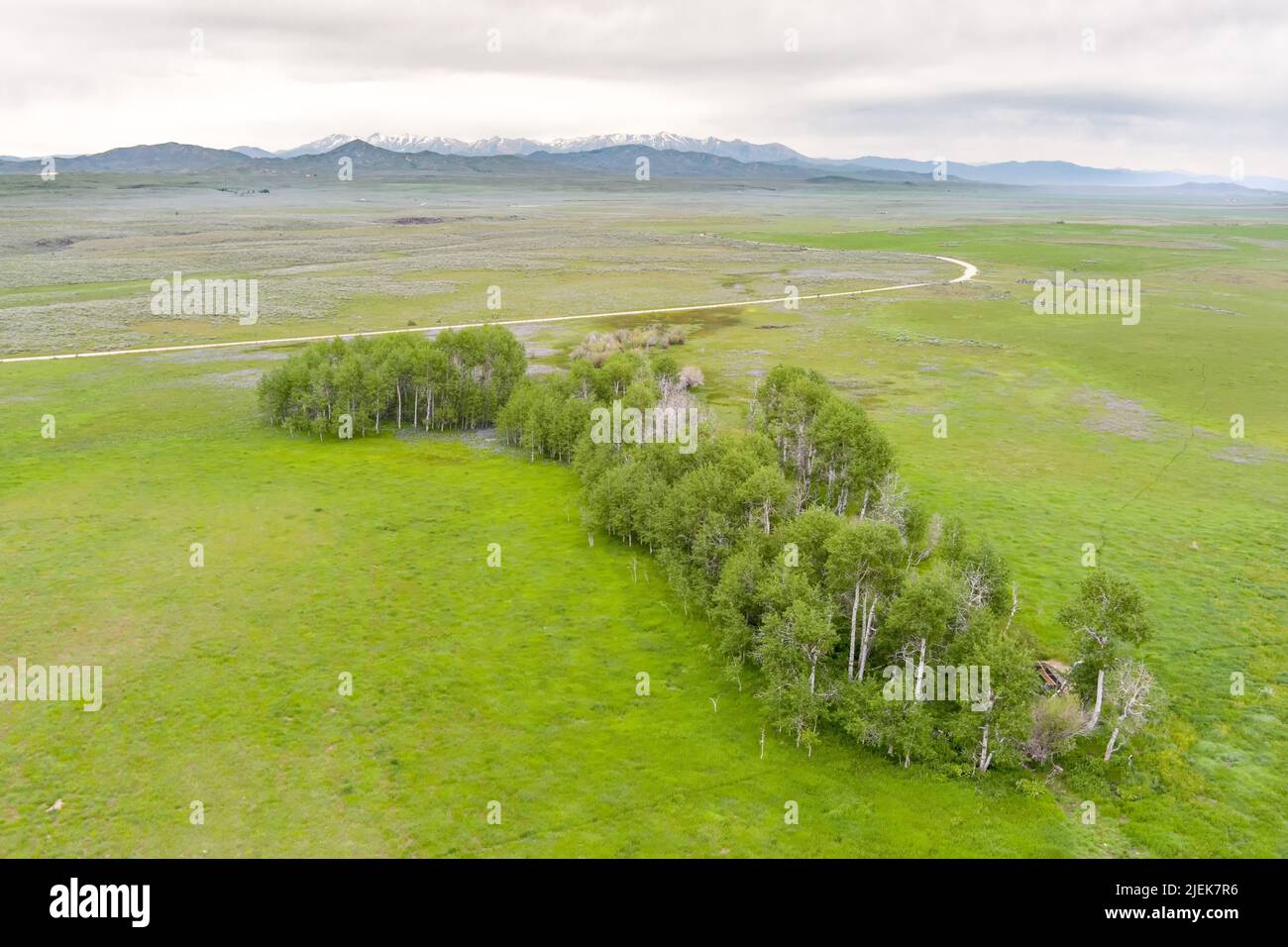 Winding dirt road and mountain range ranch land of Idaho Stock Photo ...