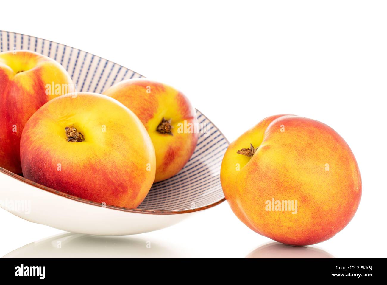 Several juicy organic nectarines with a ceramic plate, close-up ...