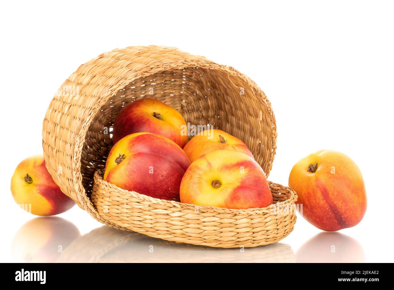 Several juicy organic nectarines with a straw basket, close-up ...