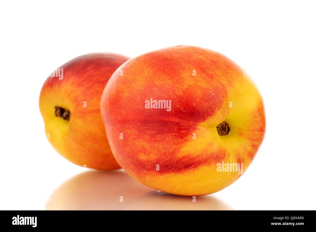 Two juicy organic nectarines, close-up, isolated on white background ...