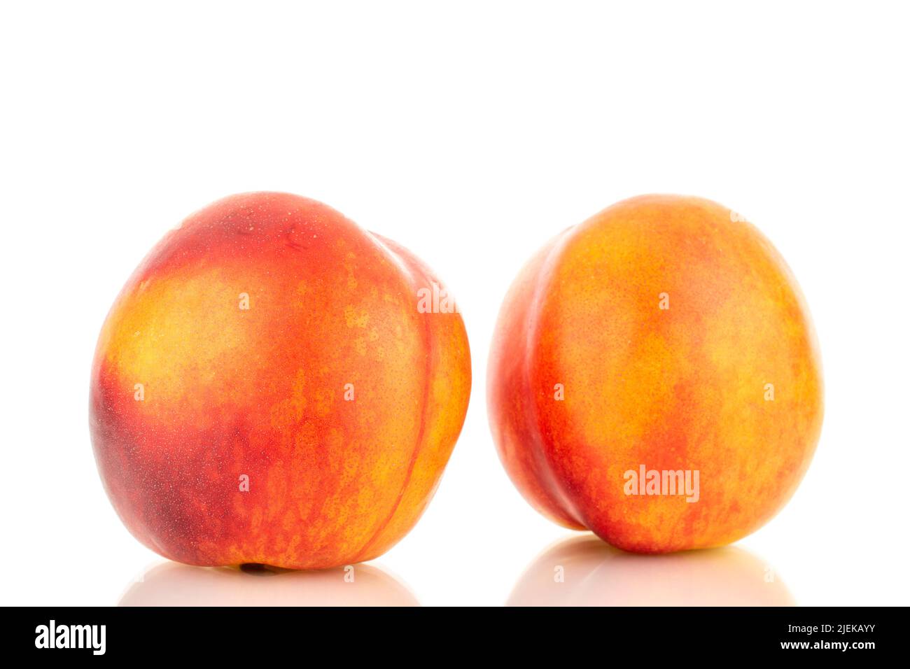 Two juicy organic nectarines, close-up, isolated on white background ...