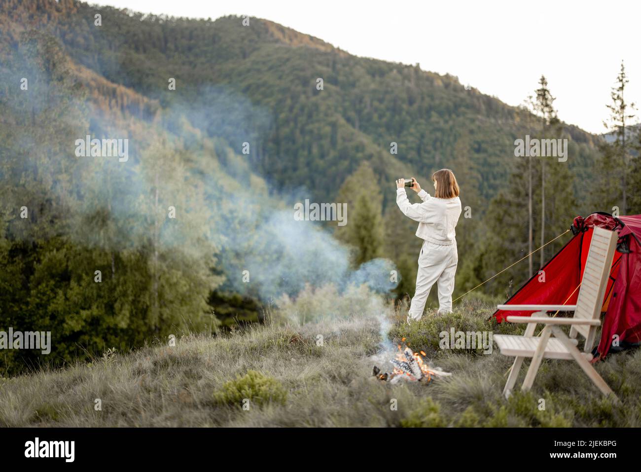 Woman takes photo of beautiful mountain range while travel Stock Photo ...