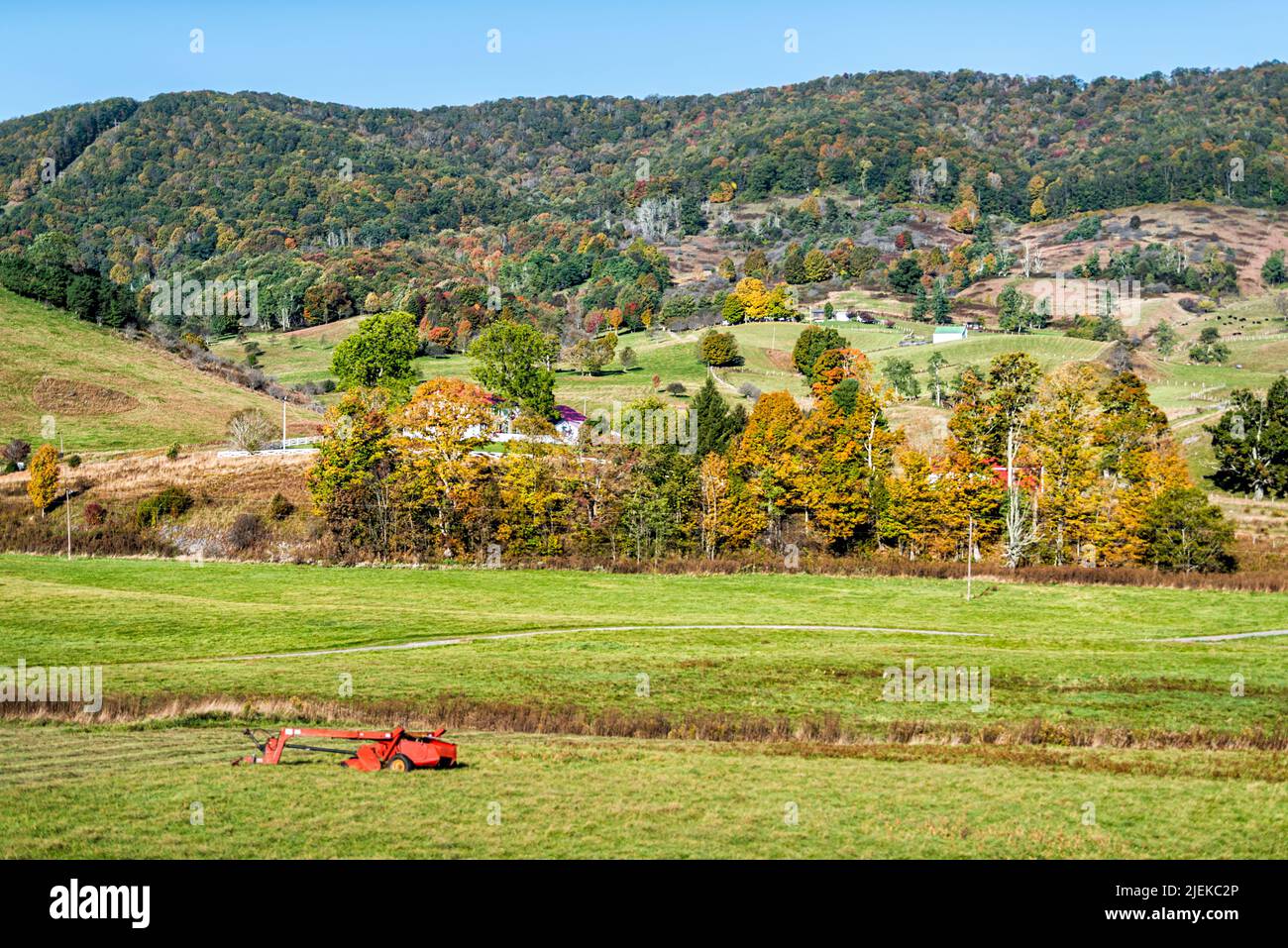 Autumn fall orange colorful trees foliage and farm houses land hills ...