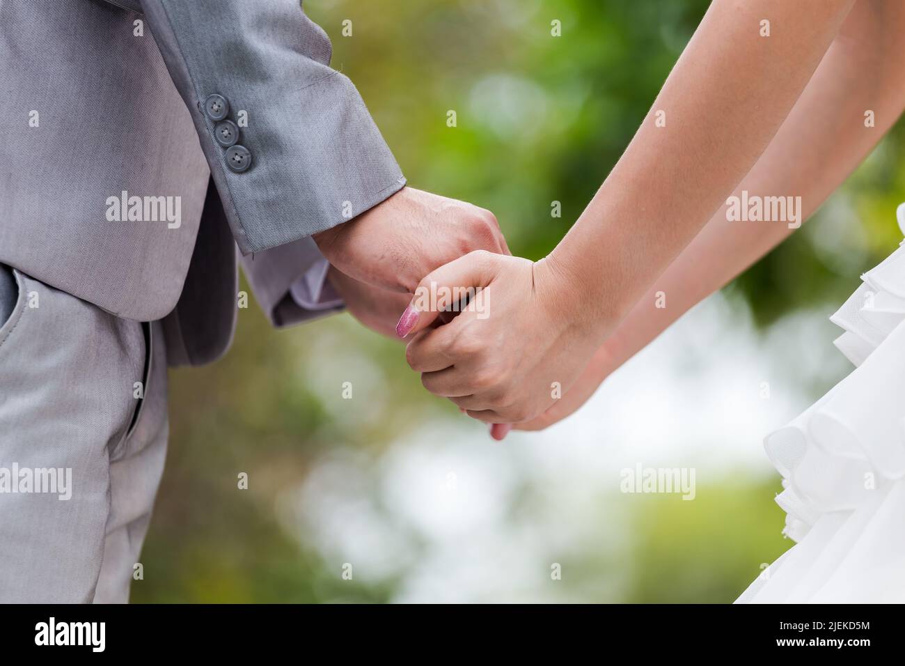Bride and groom holding hands in wedding celemony a symbol of love ...