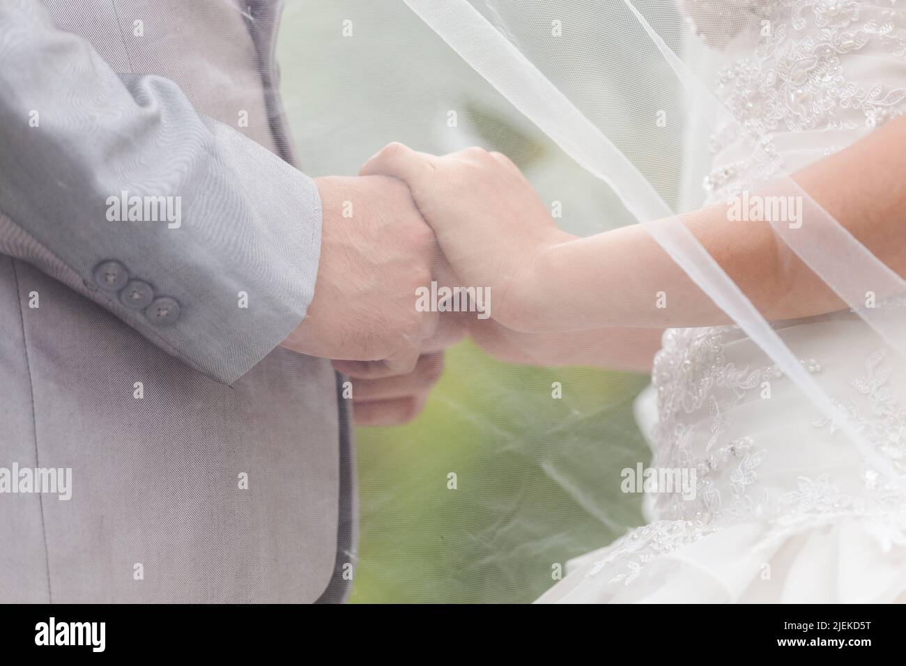 Bride and groom holding hands in wedding celemony a symbol of love ...