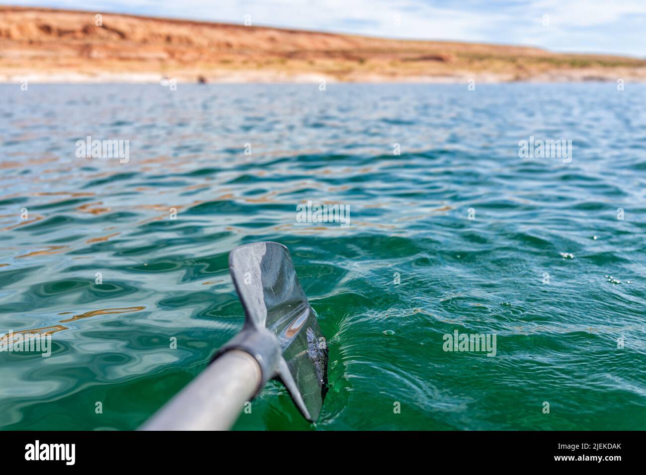 Kayaking in Lake Powell towards antelope canyon with closeup of paddle ...