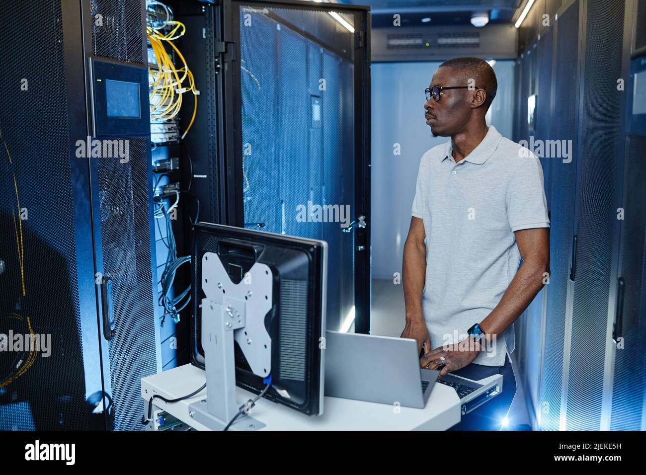 Side view portrait of black men setting up internet network and using ...