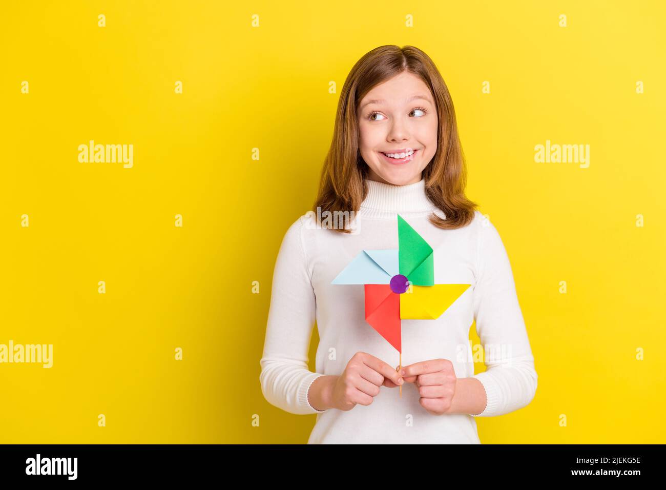 Photo of lovely adorable happy young small girl look empty space hold ...