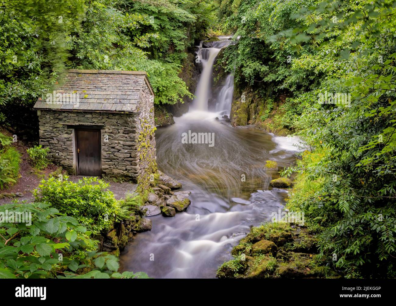A river flowing over Rydal Falls in the Lake District National Park ...