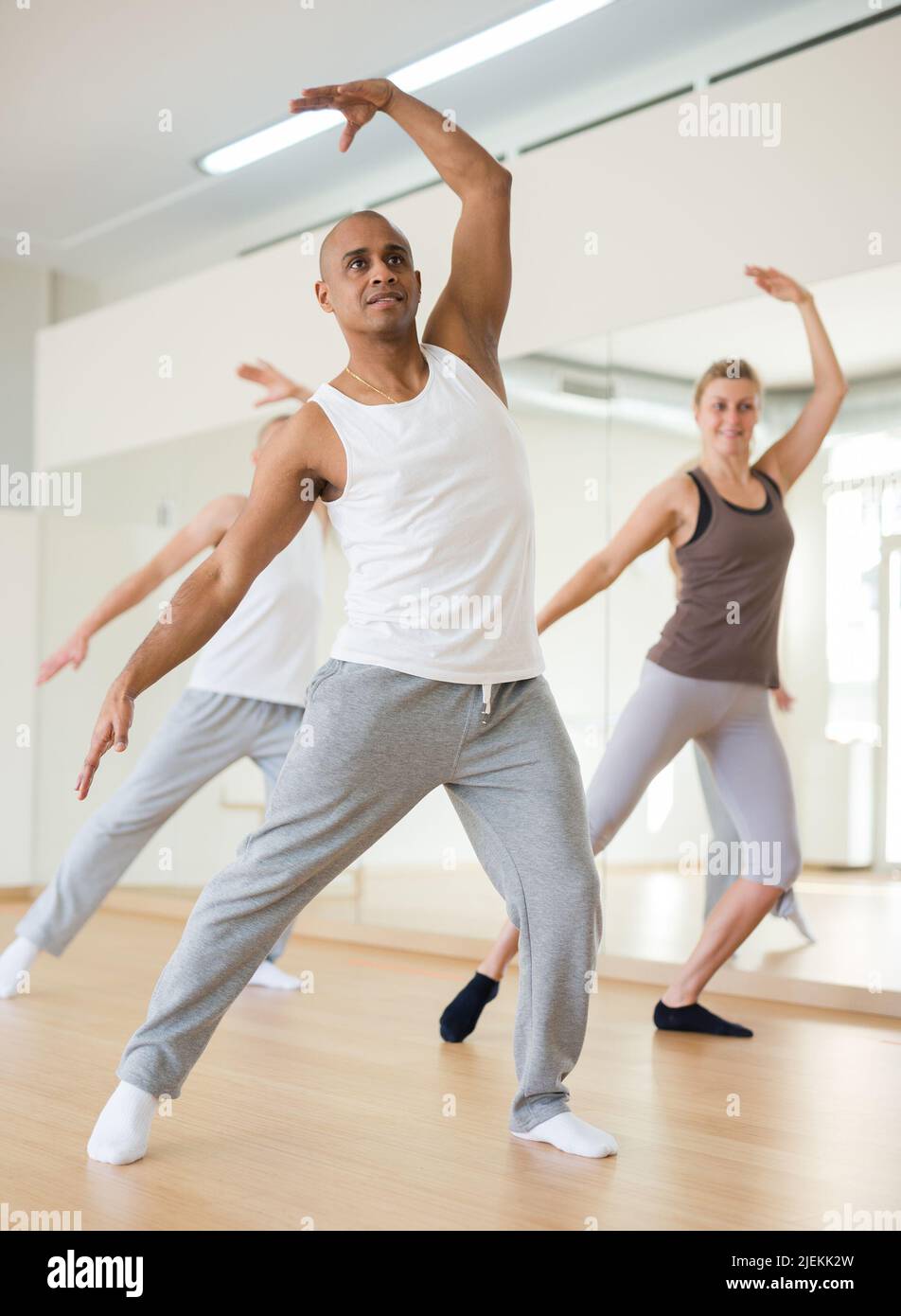 Hispanic man practicing classic dance moves during group class Stock ...