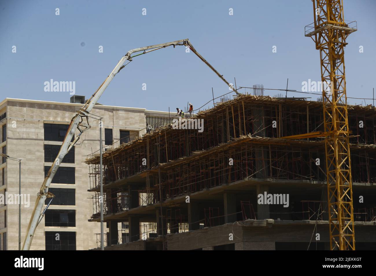 Cairo, Egypt. 27th June, 2022. Laborers work on a residential building ...